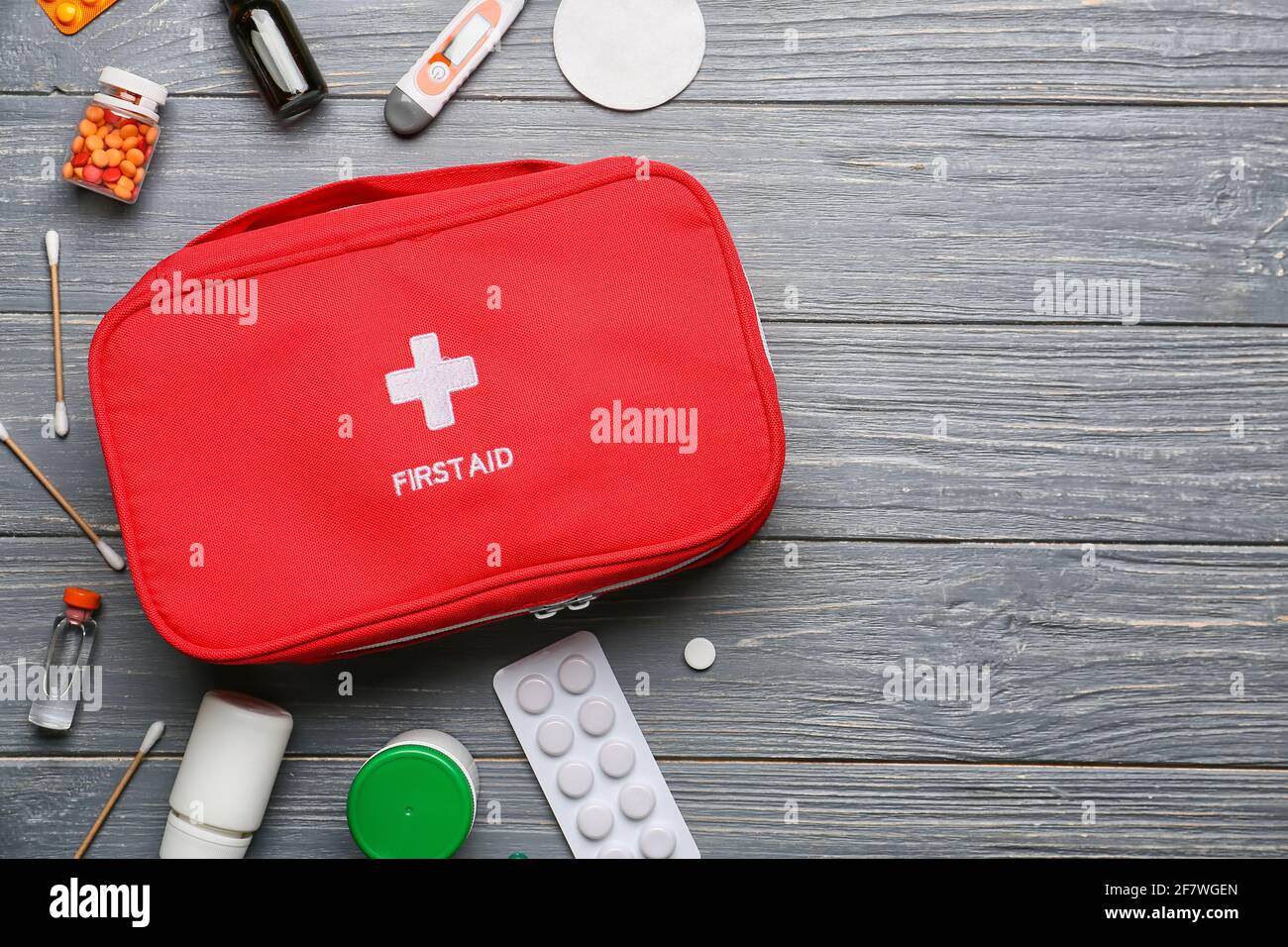 First aid kit on dark wooden background Stock Photo - Alamy