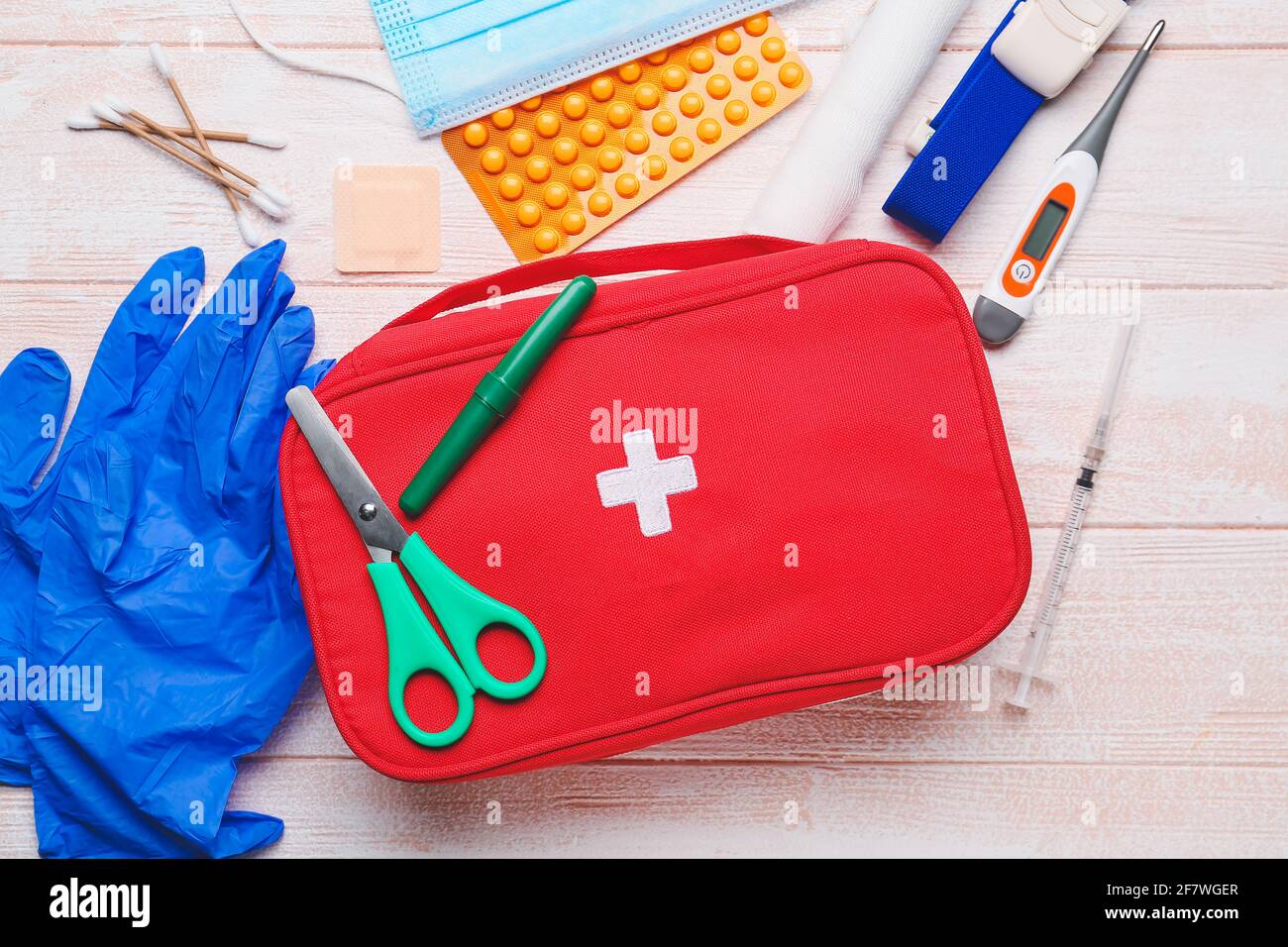 First aid kit on wooden background Stock Photo - Alamy