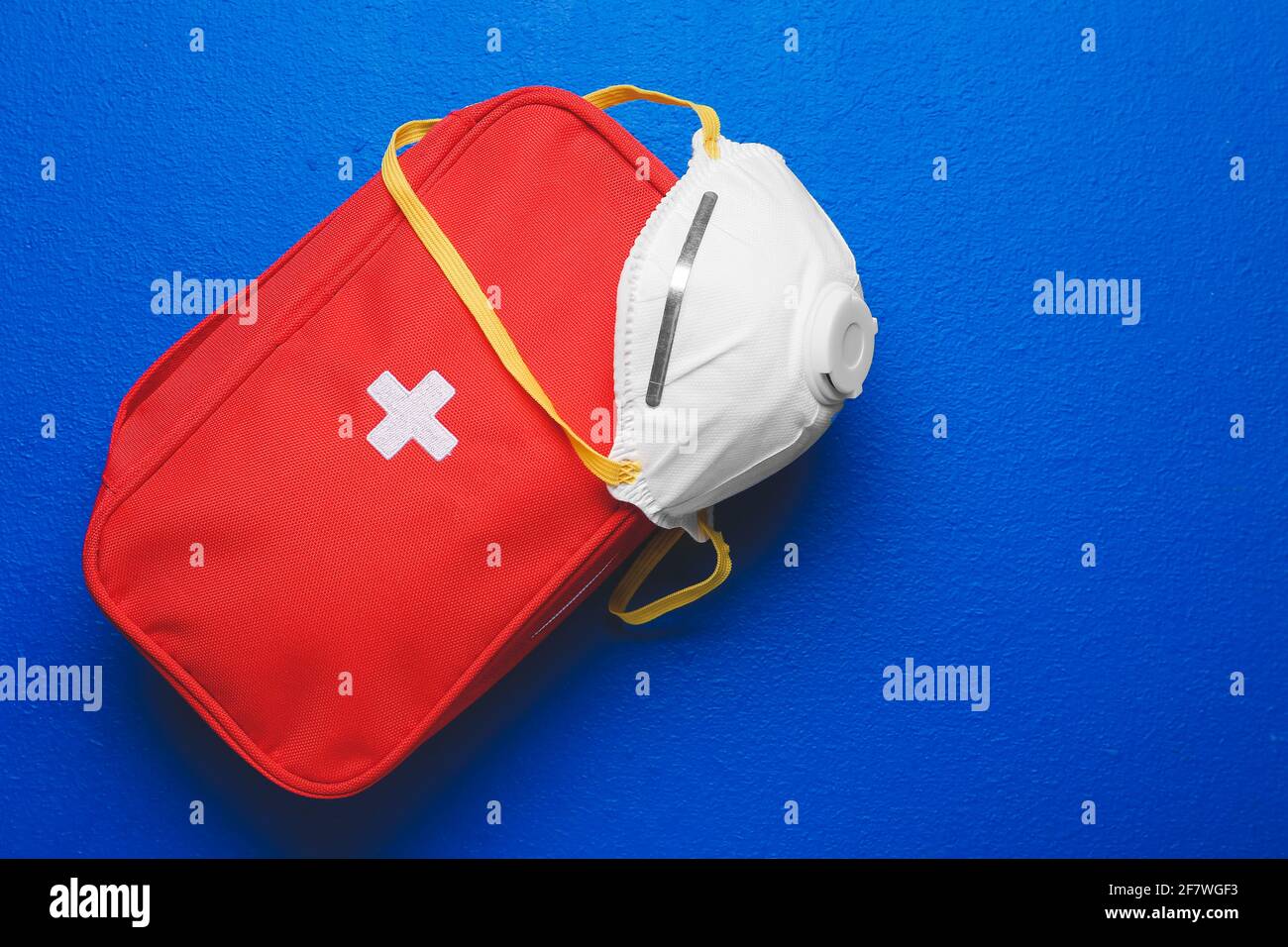 First aid kit and respirator on color background Stock Photo - Alamy