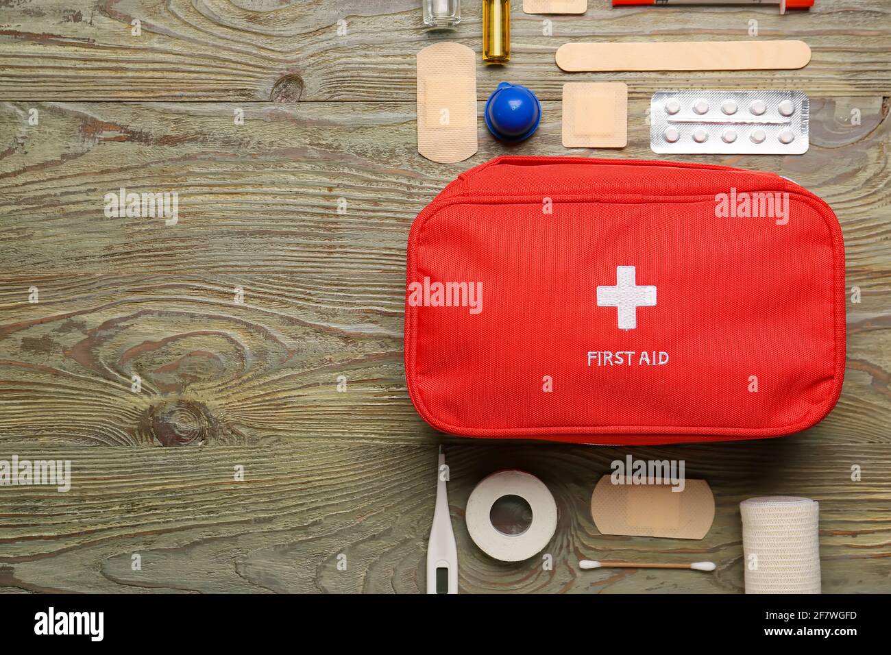First aid kit on wooden background Stock Photo - Alamy