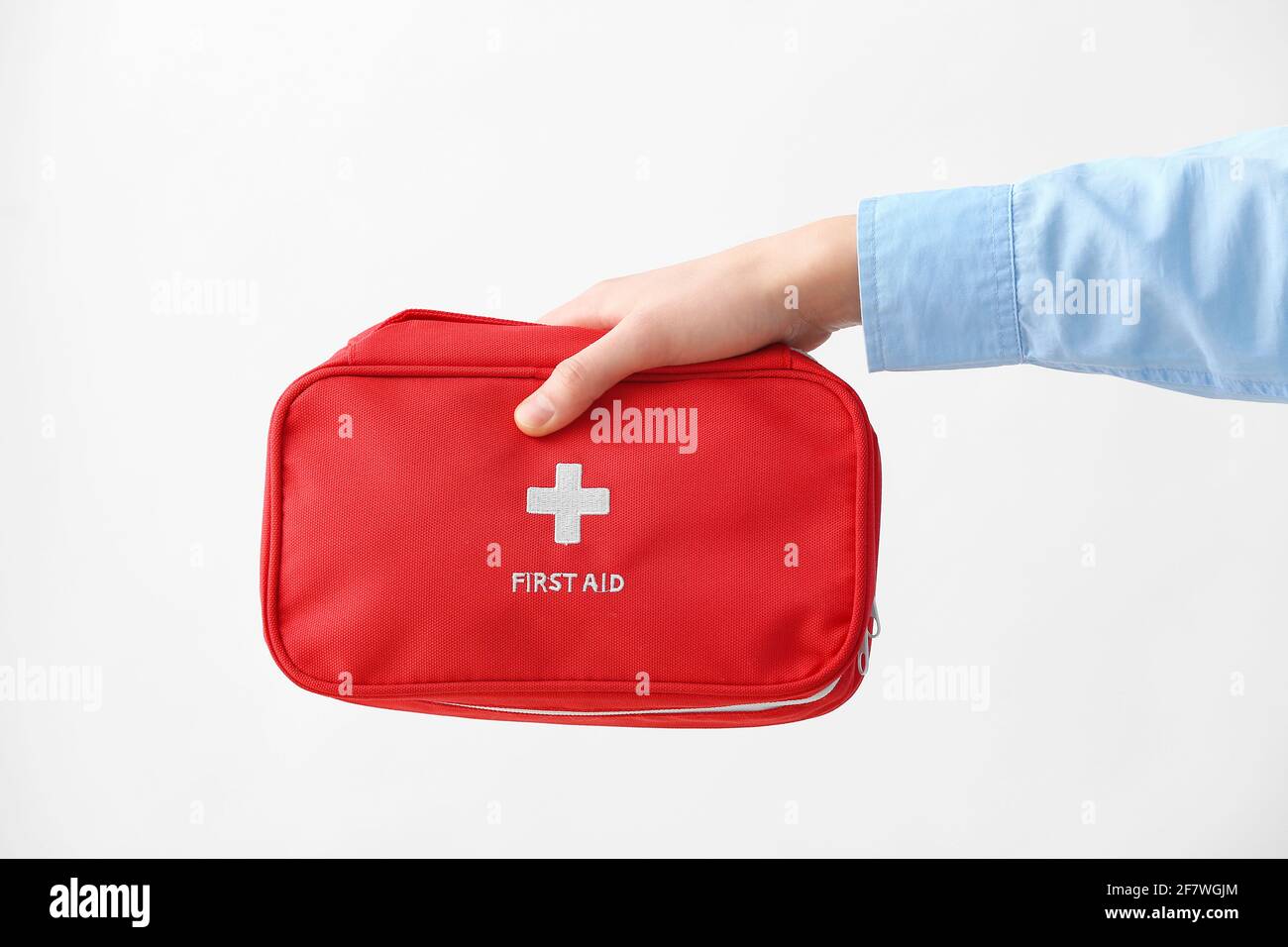 Female hand with first aid kit on white background Stock Photo - Alamy