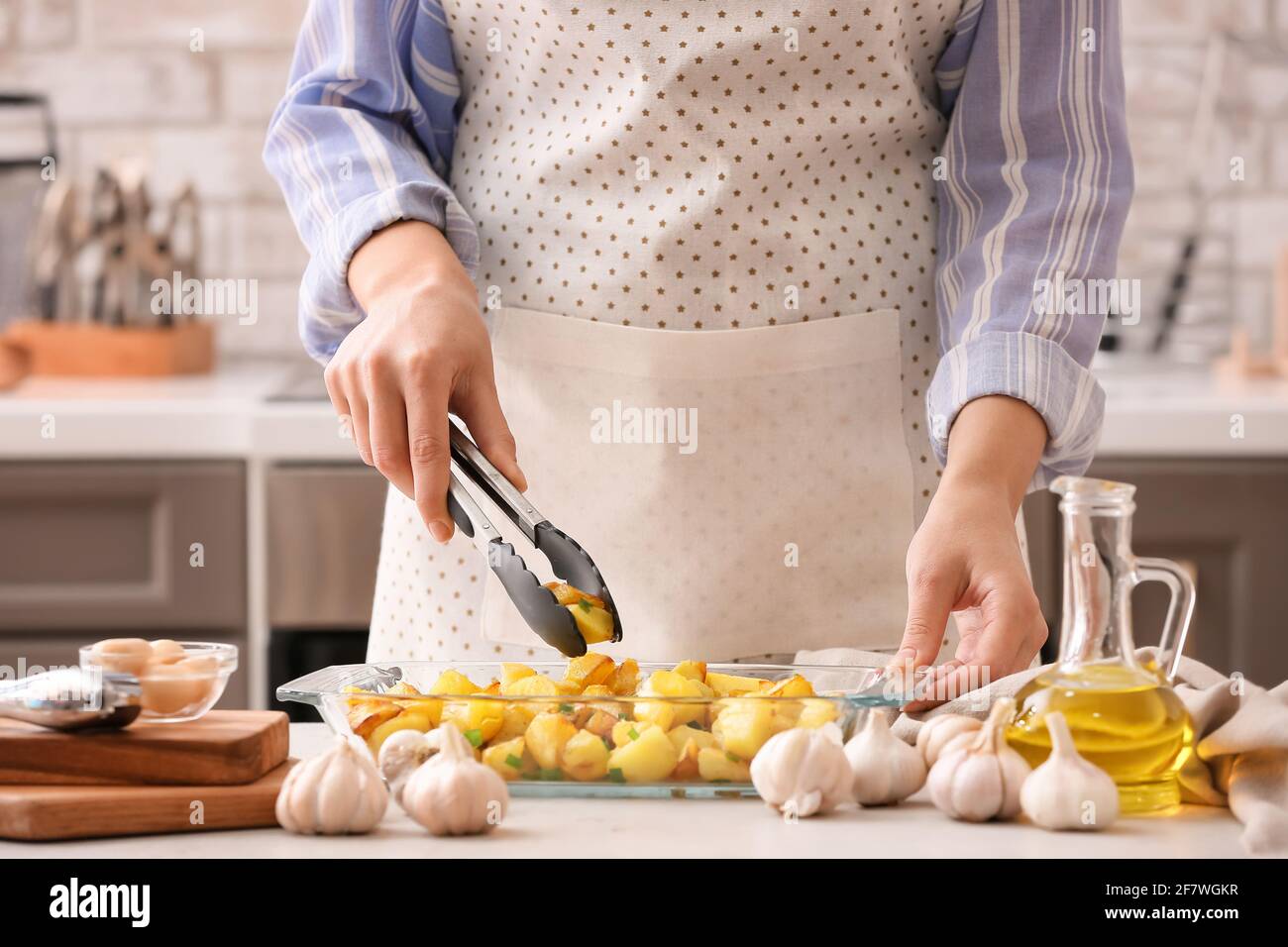Woman hands cooking baked potatoes hi-res stock photography and images ...