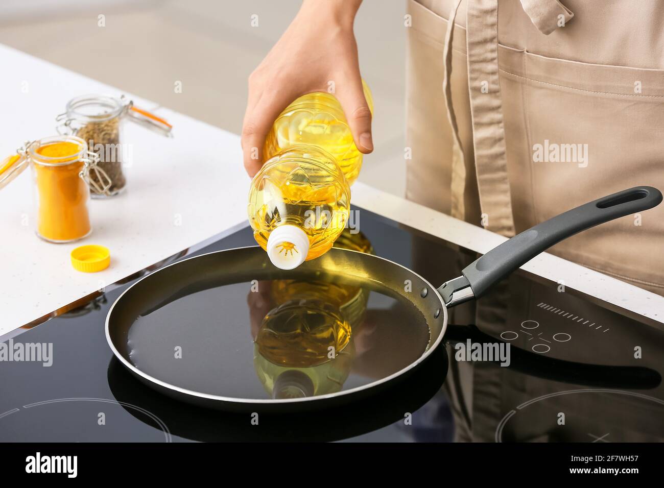 Woman pouring oil onto hi-res stock photography and images - Alamy