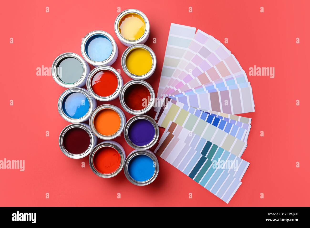 Cans of paints with palette samples on color background Stock Photo - Alamy