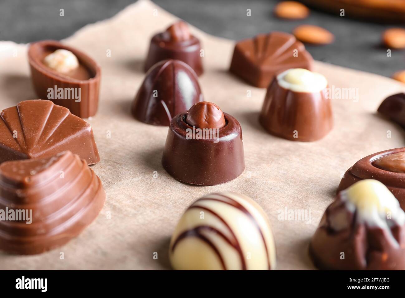 Parchment with tasty chocolate candies, closeup Stock Photo - Alamy
