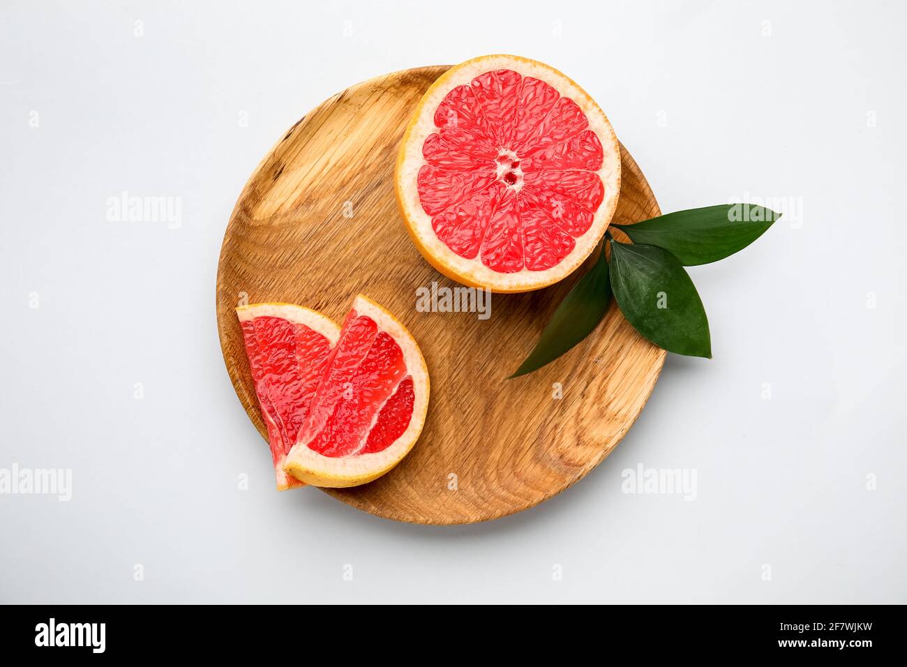 Plate with fresh sliced grapefruit on white background Stock Photo - Alamy