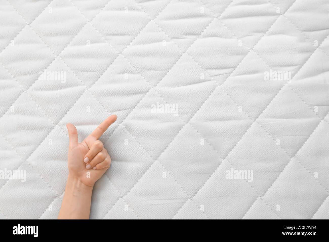 Female hand on soft orthopedic mattress Stock Photo - Alamy