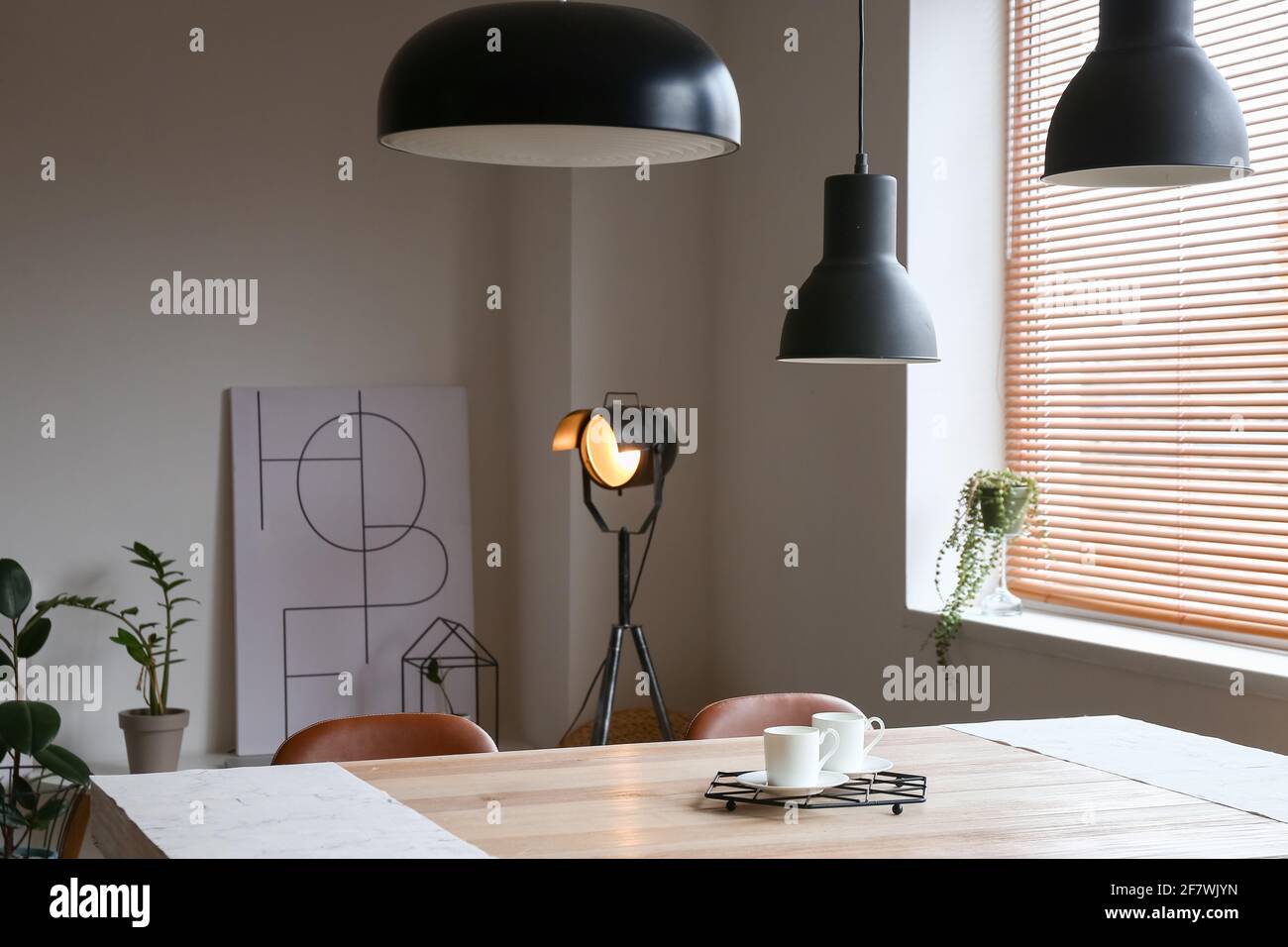Interior of modern room with table and lamps Stock Photo - Alamy