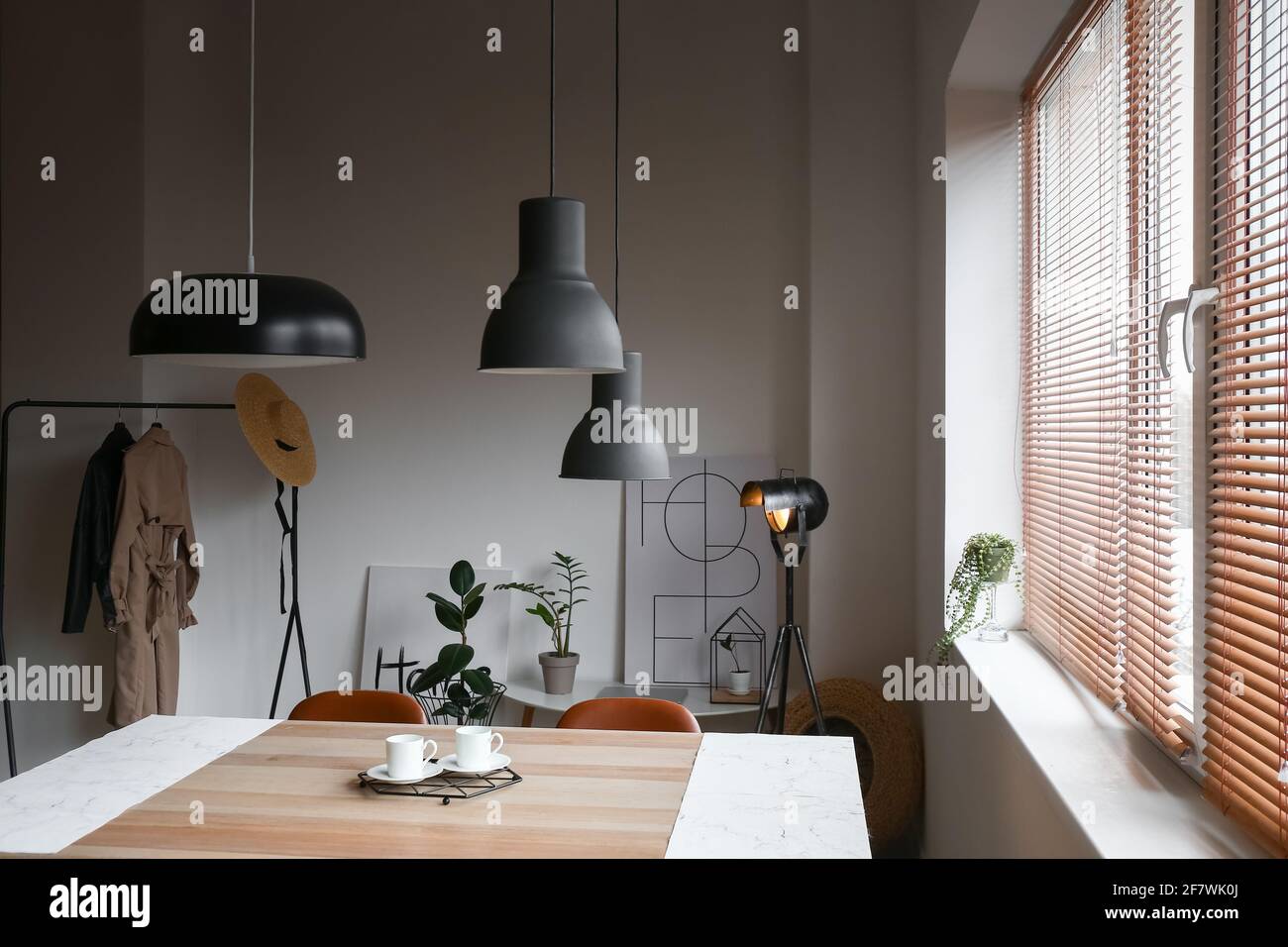 Interior of modern room with table and lamps Stock Photo - Alamy