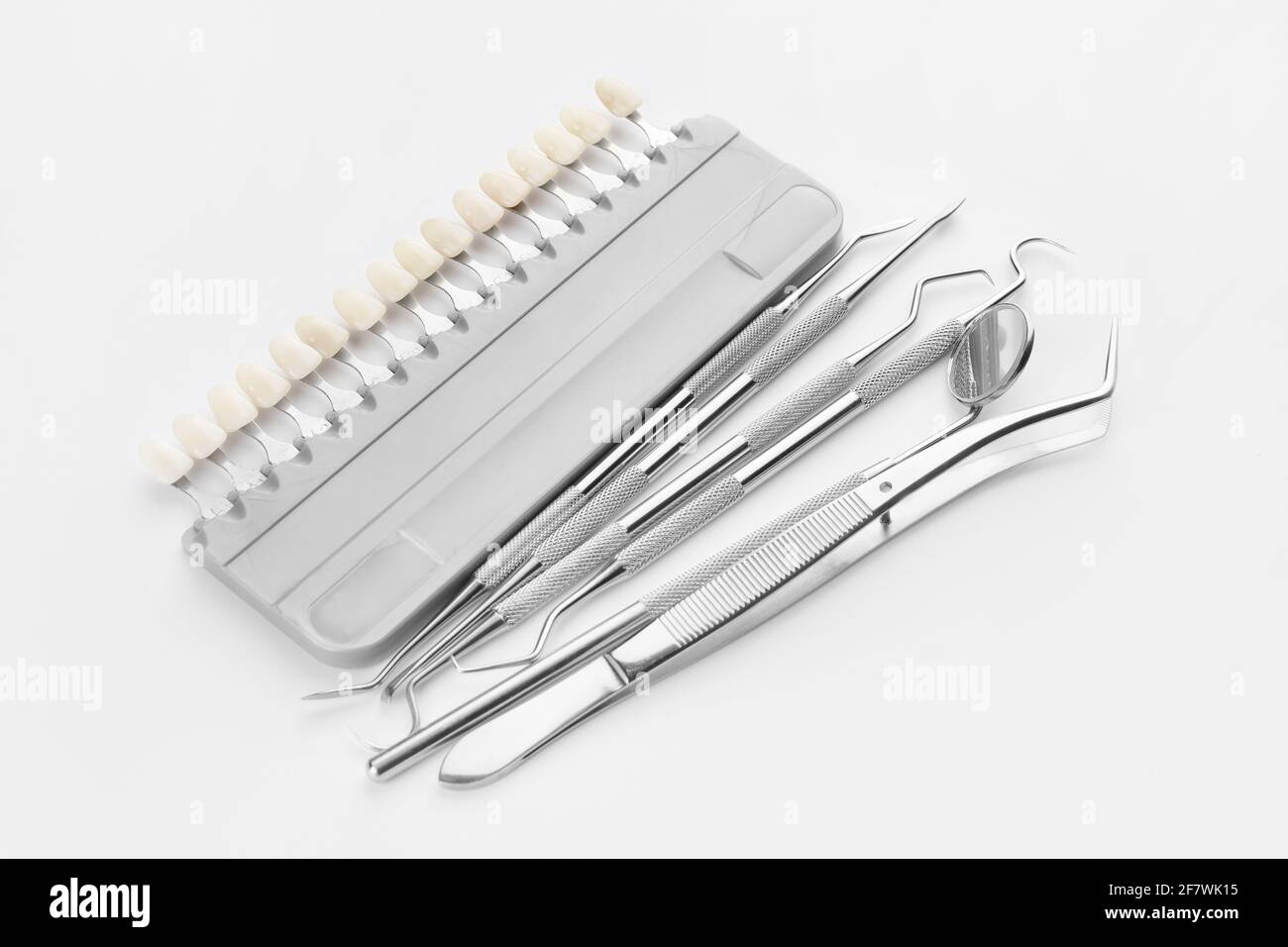 Dentist's tools and teeth color samples on white background Stock Photo ...