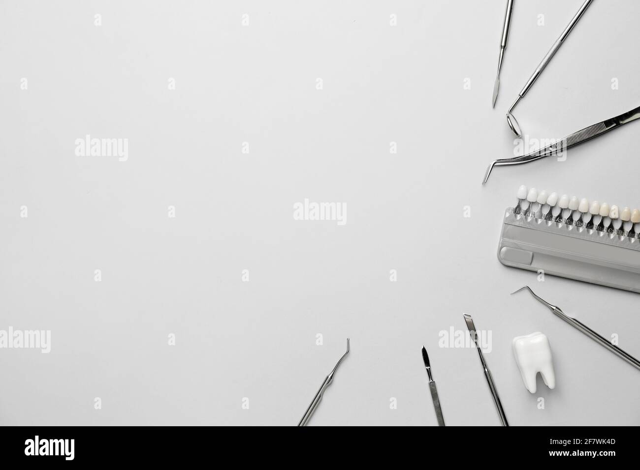 Dentist's tools and teeth color samples on light background Stock Photo ...