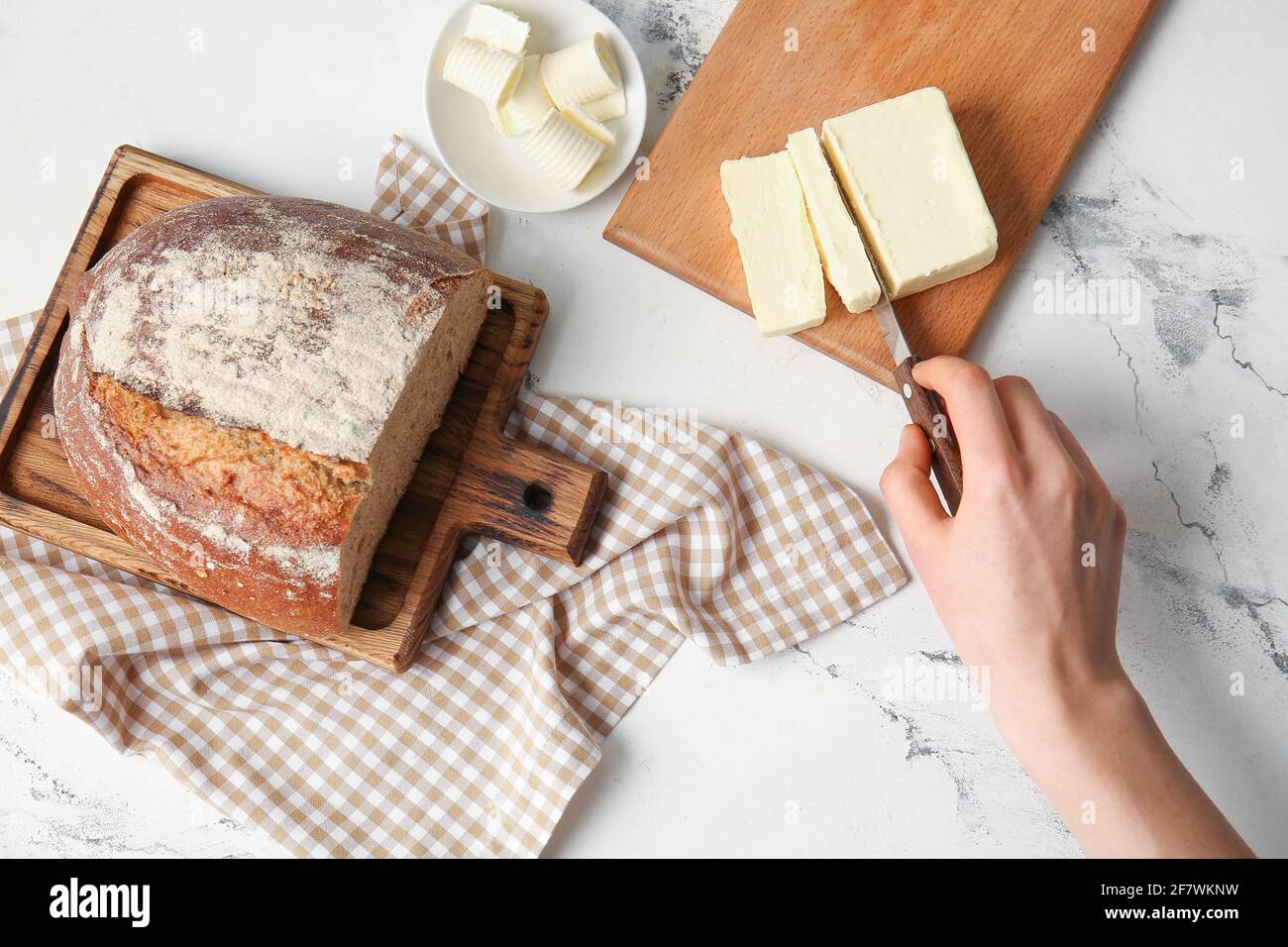 Hand with knife cutting butter hi-res stock photography and images - Alamy