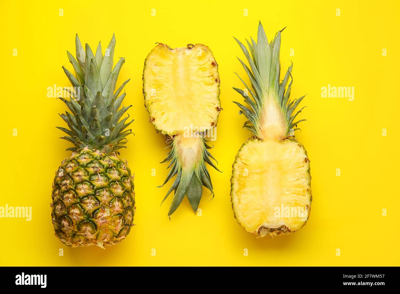 Fresh pineapples on color background Stock Photo - Alamy