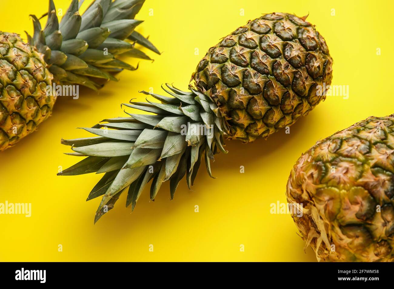 Fresh pineapples on color background Stock Photo - Alamy