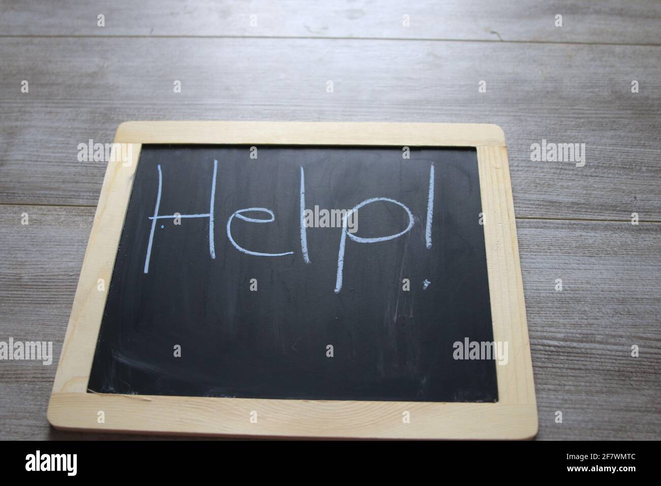 Small blackboard on the floor with help written on it with chalks Stock ...