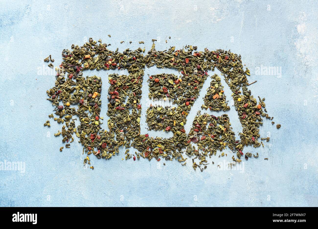 Word TEA made of dry green leaves on color background Stock Photo - Alamy