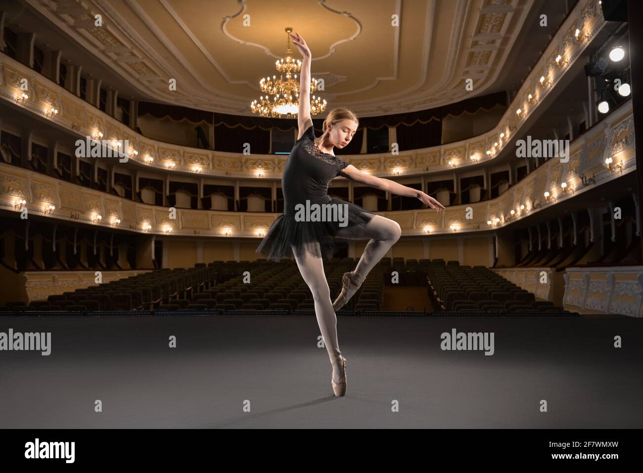 Beautiful young ballerina dancing in theatre Stock Photo - Alamy