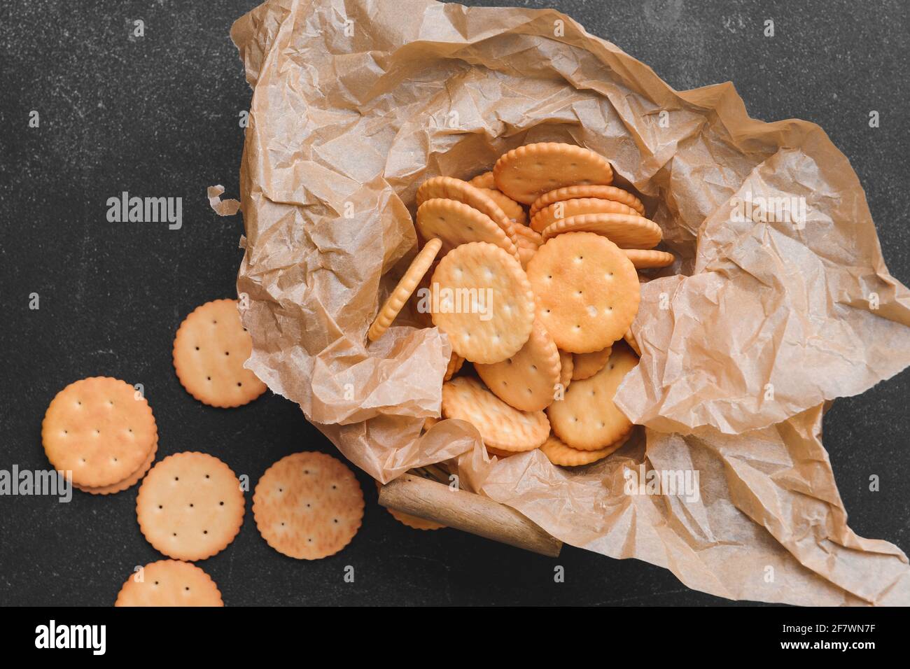 Parchment paper with crackers on dark background Stock Photo - Alamy
