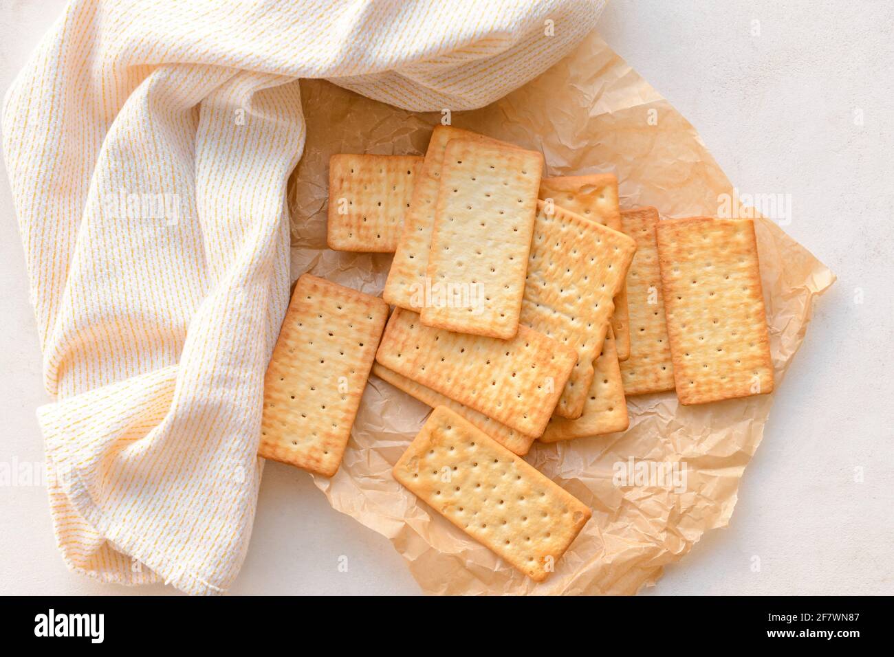 Parchment paper with crackers on light background Stock Photo - Alamy