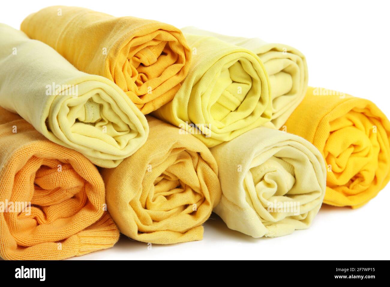 Rolled clean clothes on white background Stock Photo - Alamy
