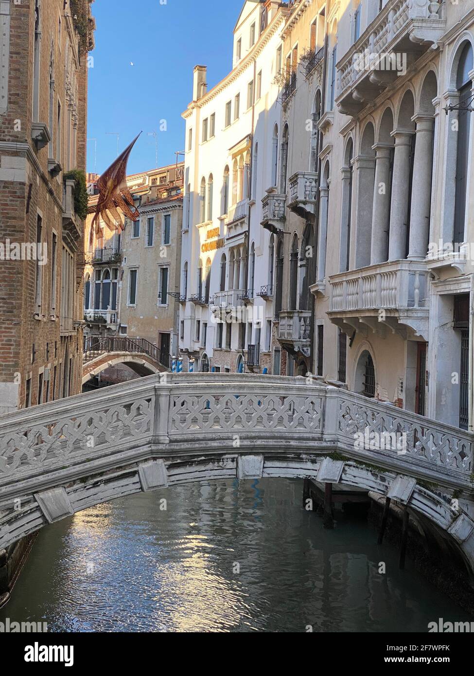 Beautiful bridge over a small canal lined, on colorful building ...