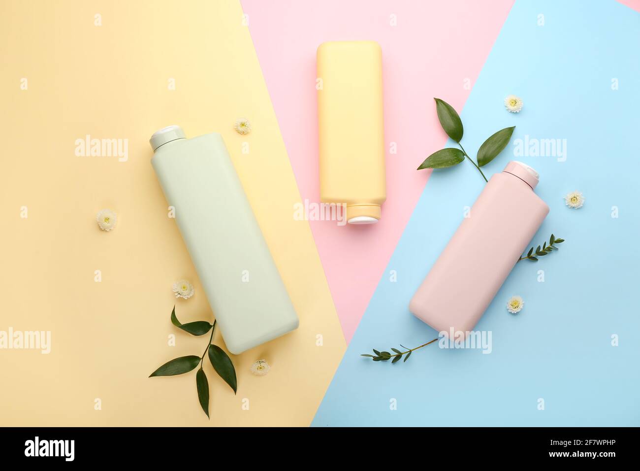 Shower gels and flowers on color background Stock Photo - Alamy