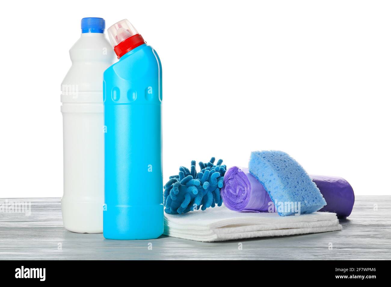 Set of cleaning supplies on wooden table against white background Stock ...