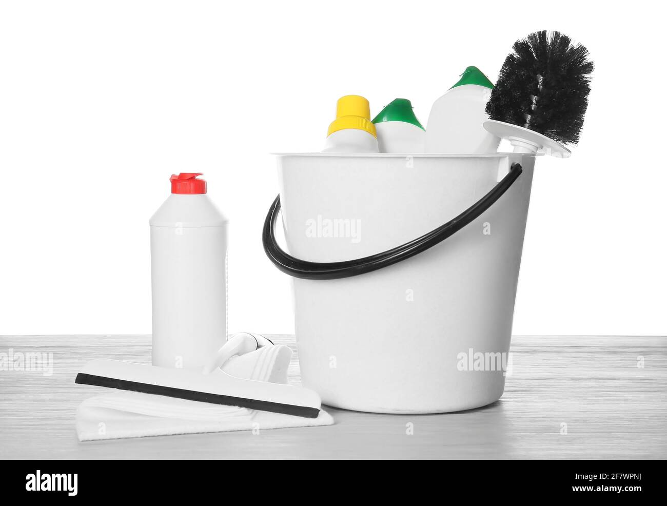 Set of cleaning supplies on wooden table against white background Stock ...
