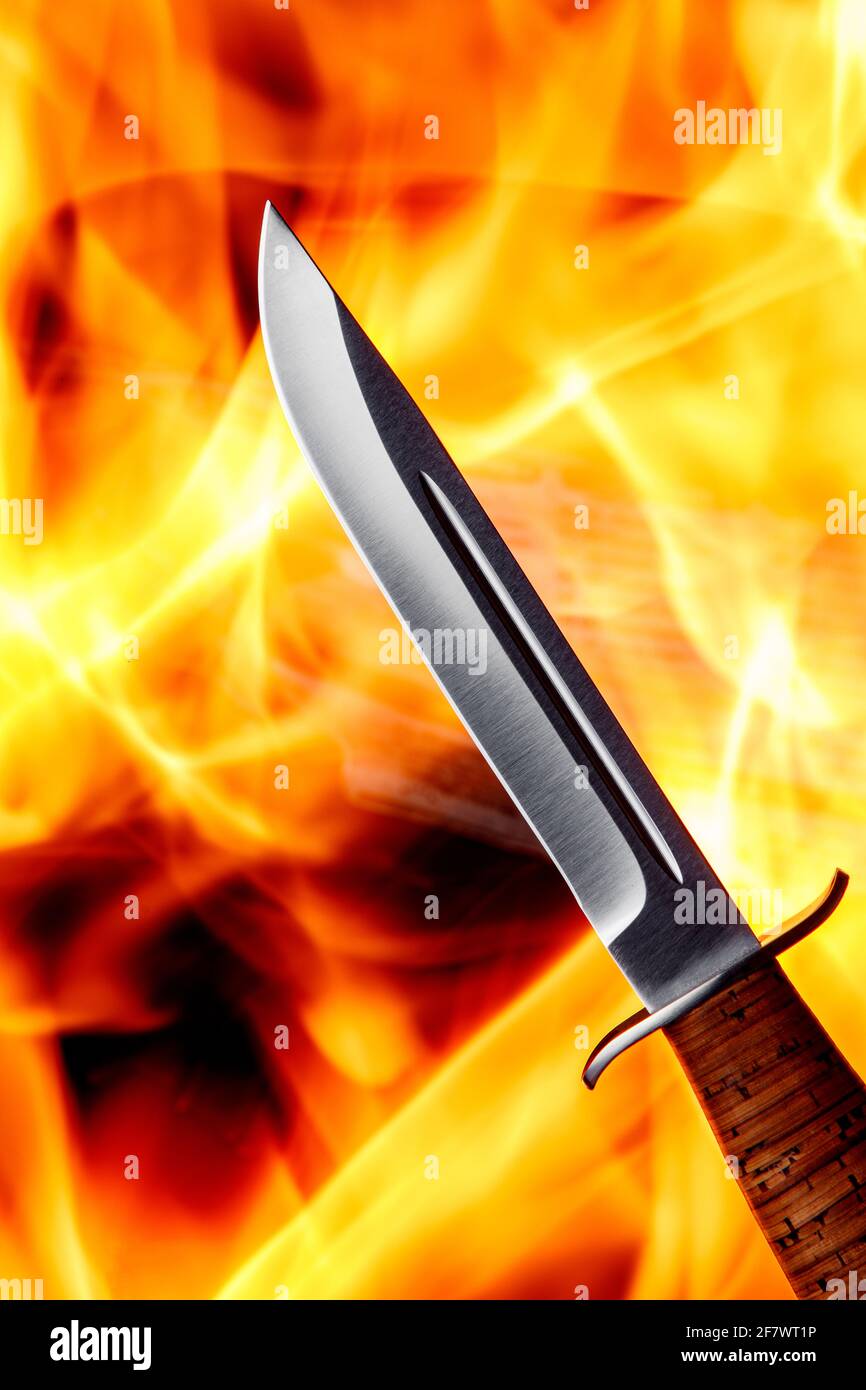 Damascus steel knife on the fire background Stock Photo - Alamy