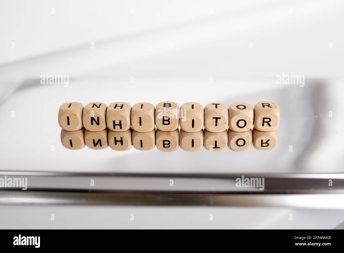 Word inhibitor made by wooden cubes Stock Photo - Alamy