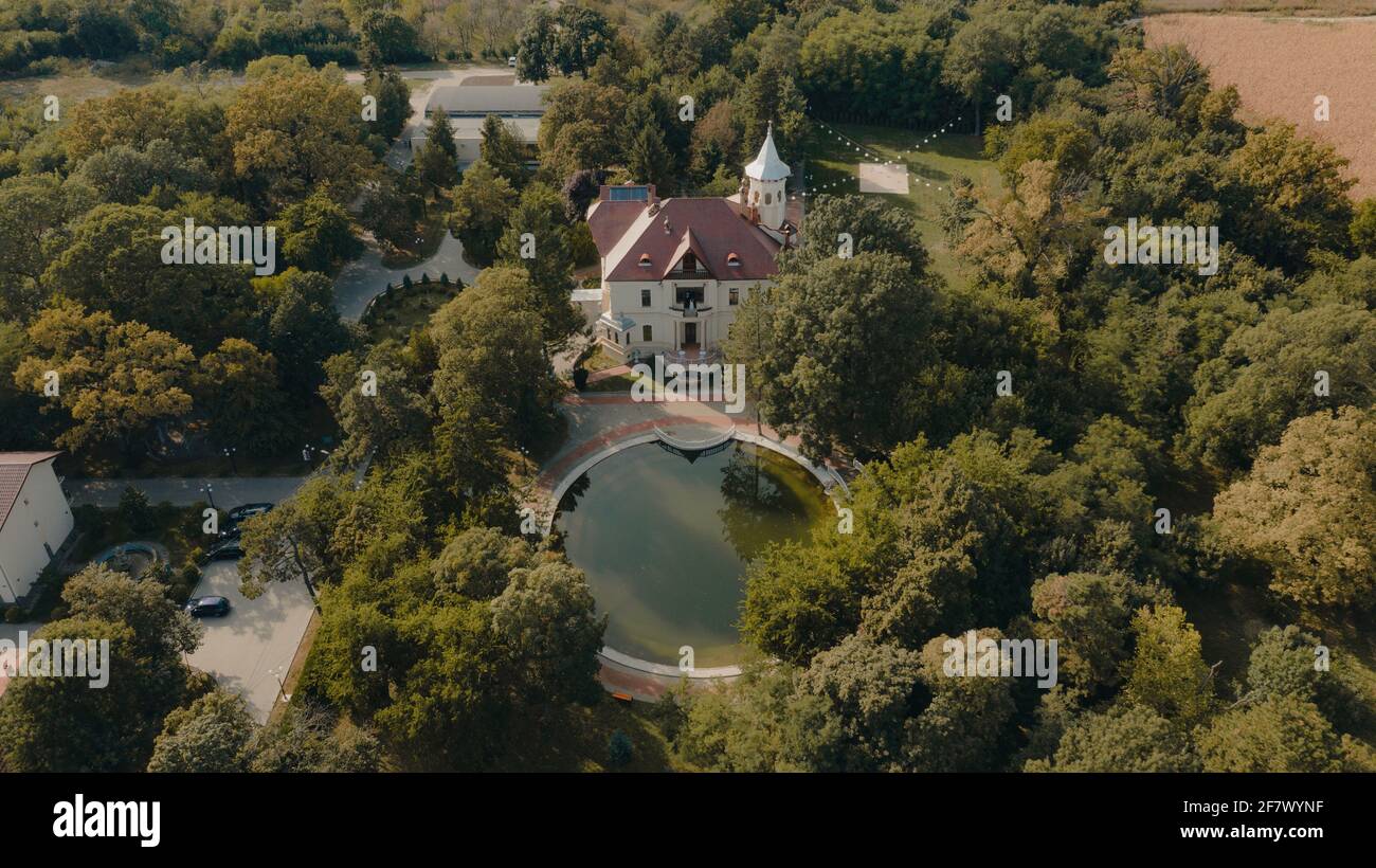 Aerial view of a majestic countryside house with a pond in the backyard ...