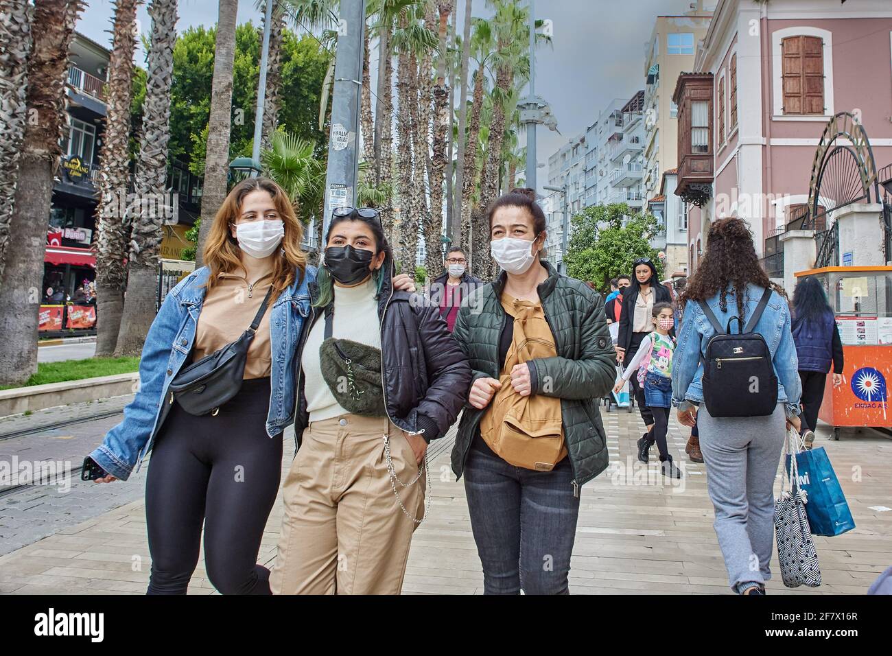 Women wearing face masks to protect against coronavirus, walk in a ...