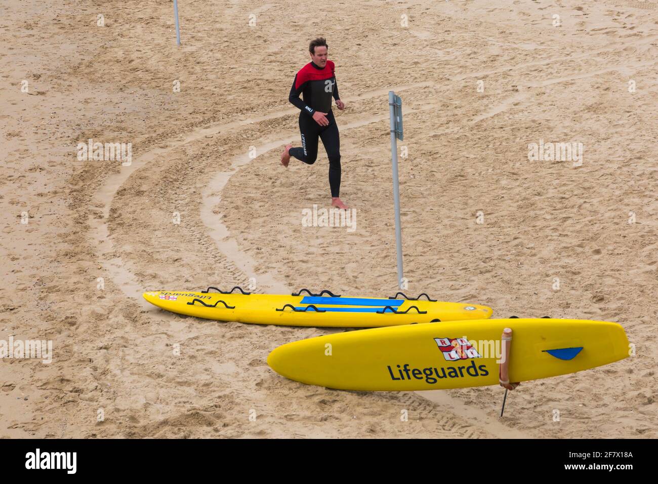 Lifeguard running along beach hi-res stock photography and images - Alamy