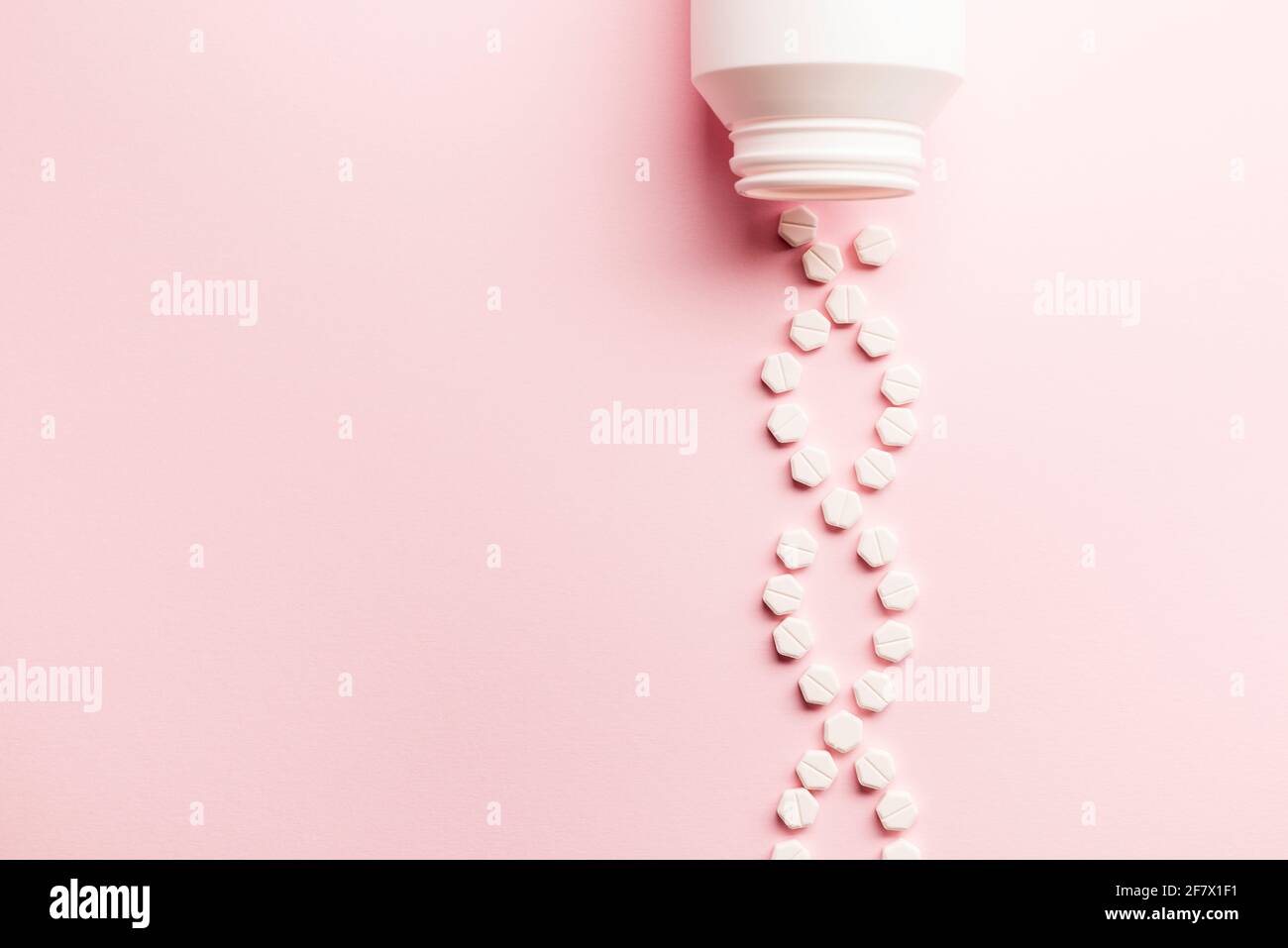 Medicine pills dna shape with bottle on pink background Stock Photo - Alamy