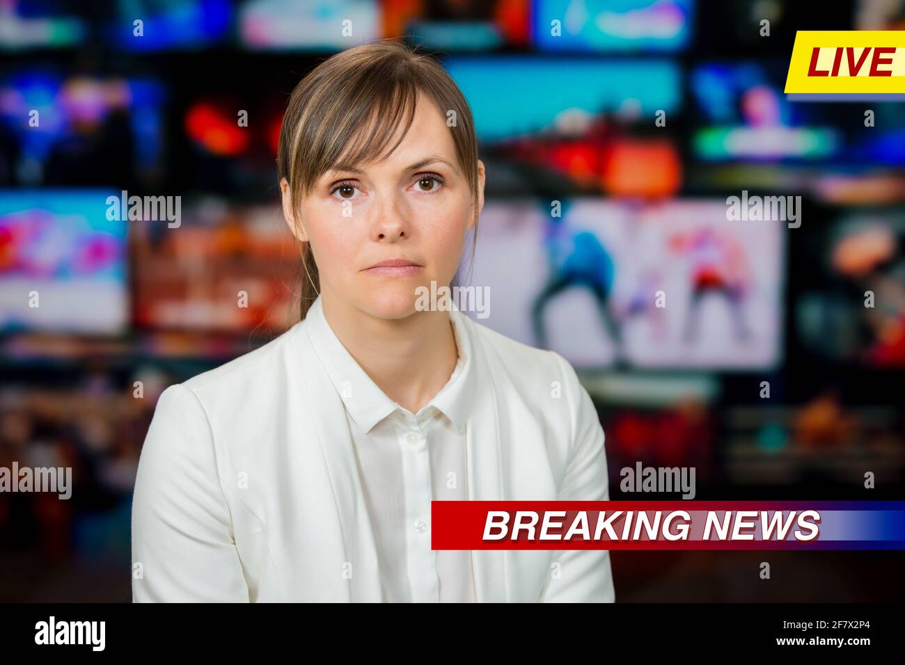An anchorwoman reporting live breaking news sitting in Tv studio ...