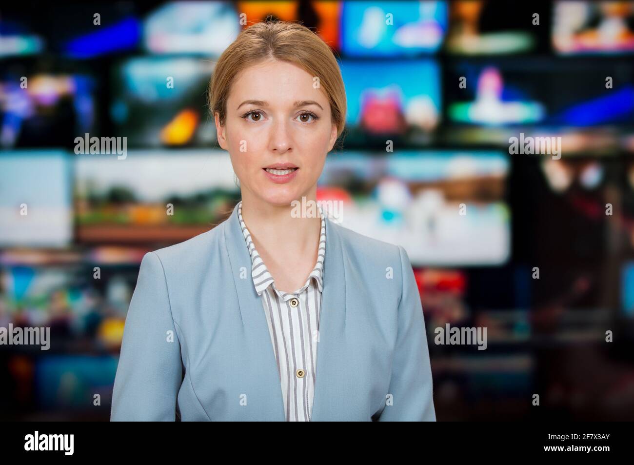 An anchorwoman reporting live breaking news sitting in Tv studio ...
