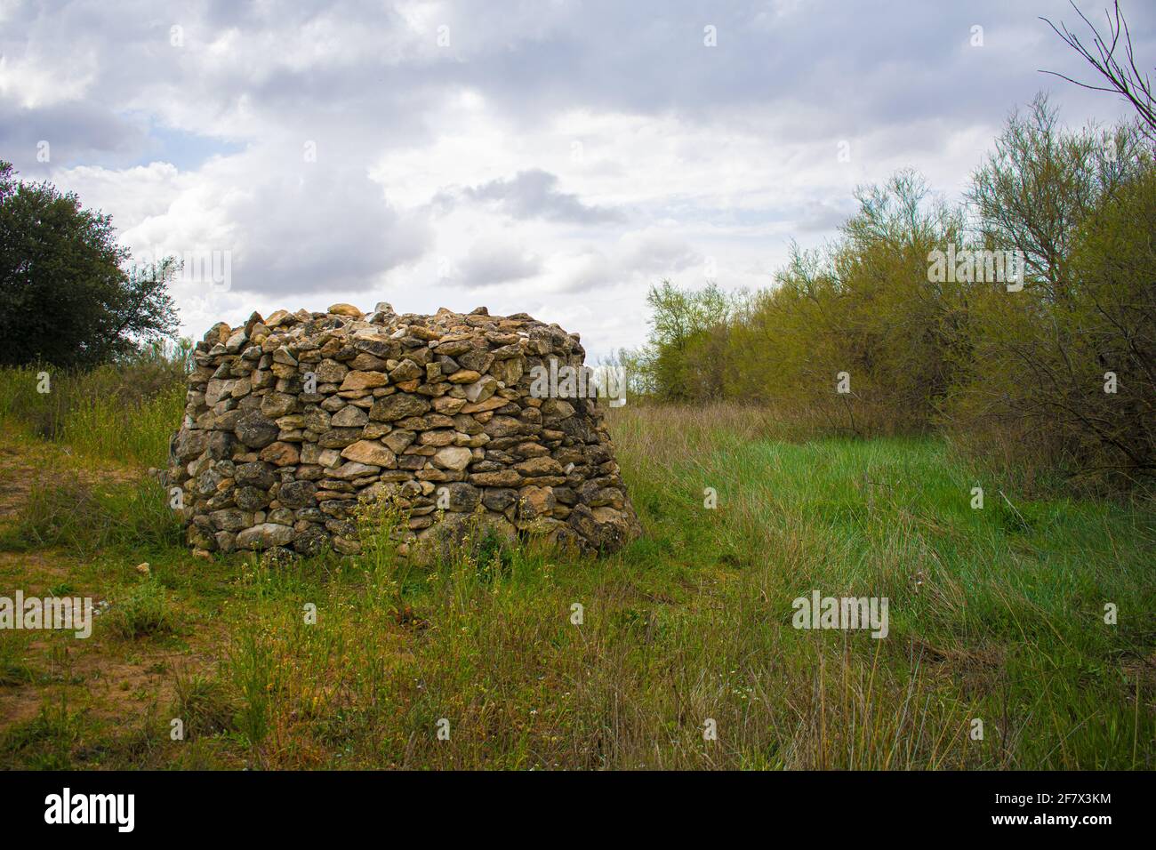 Horizontal shot of ruins of an ancient stone building in the field ...