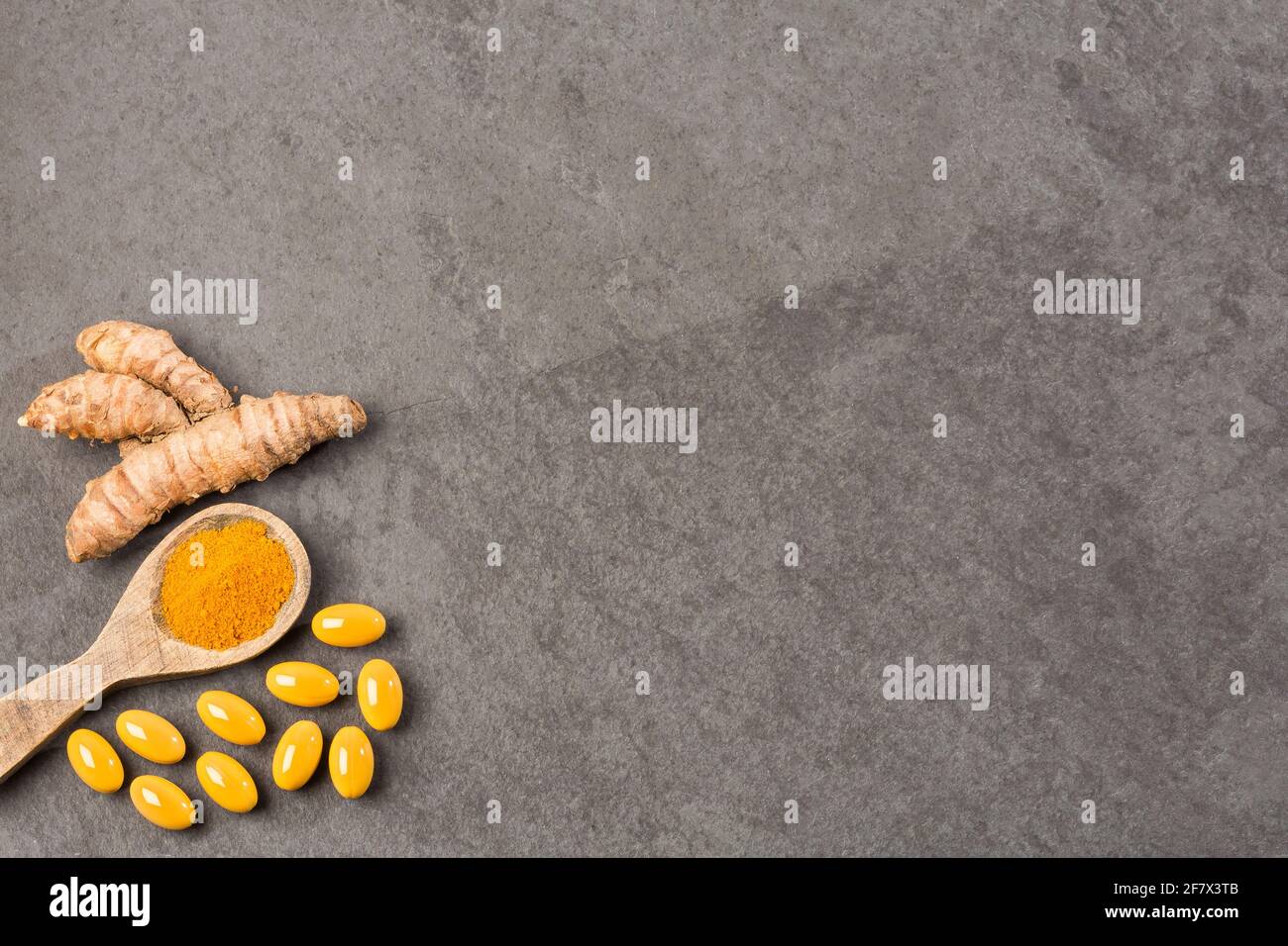Roots, powder and turmeric pills - Curcuma longa Stock Photo - Alamy