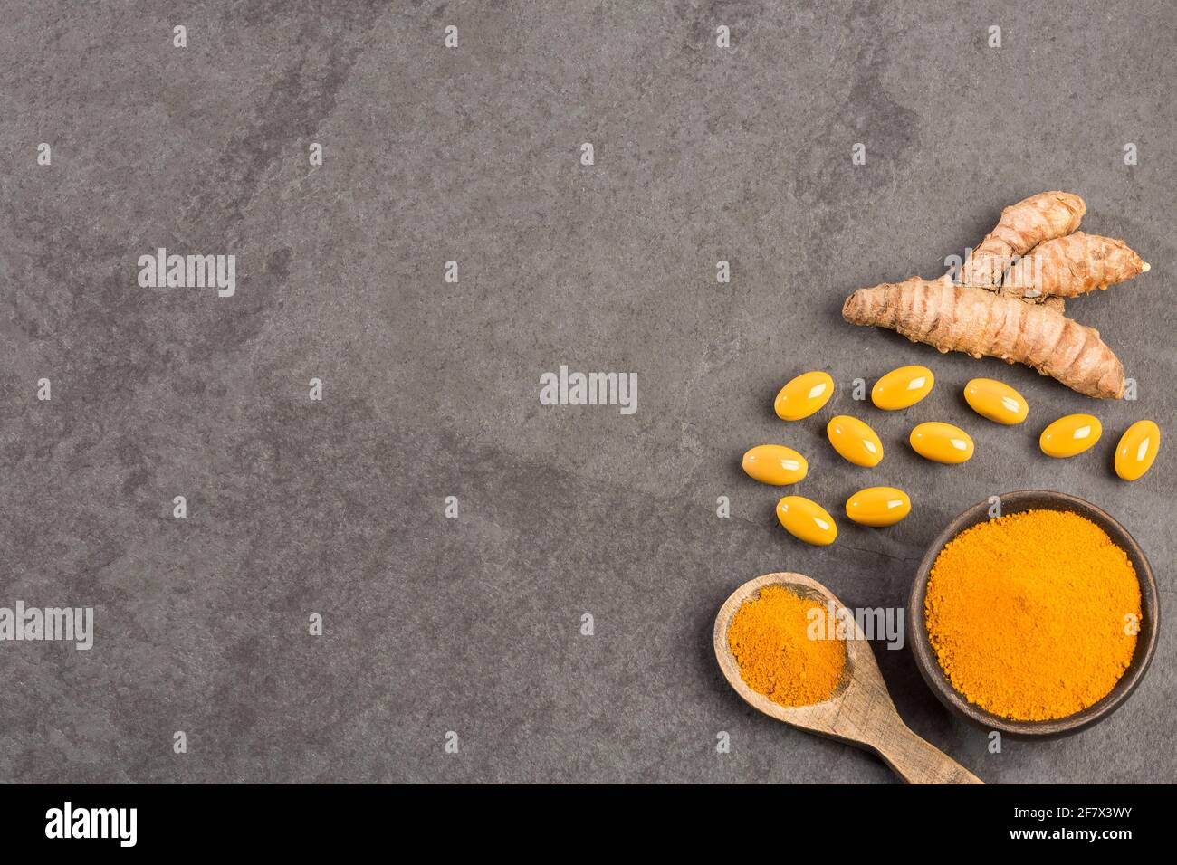 Roots, powder and turmeric pills - Curcuma longa Stock Photo - Alamy