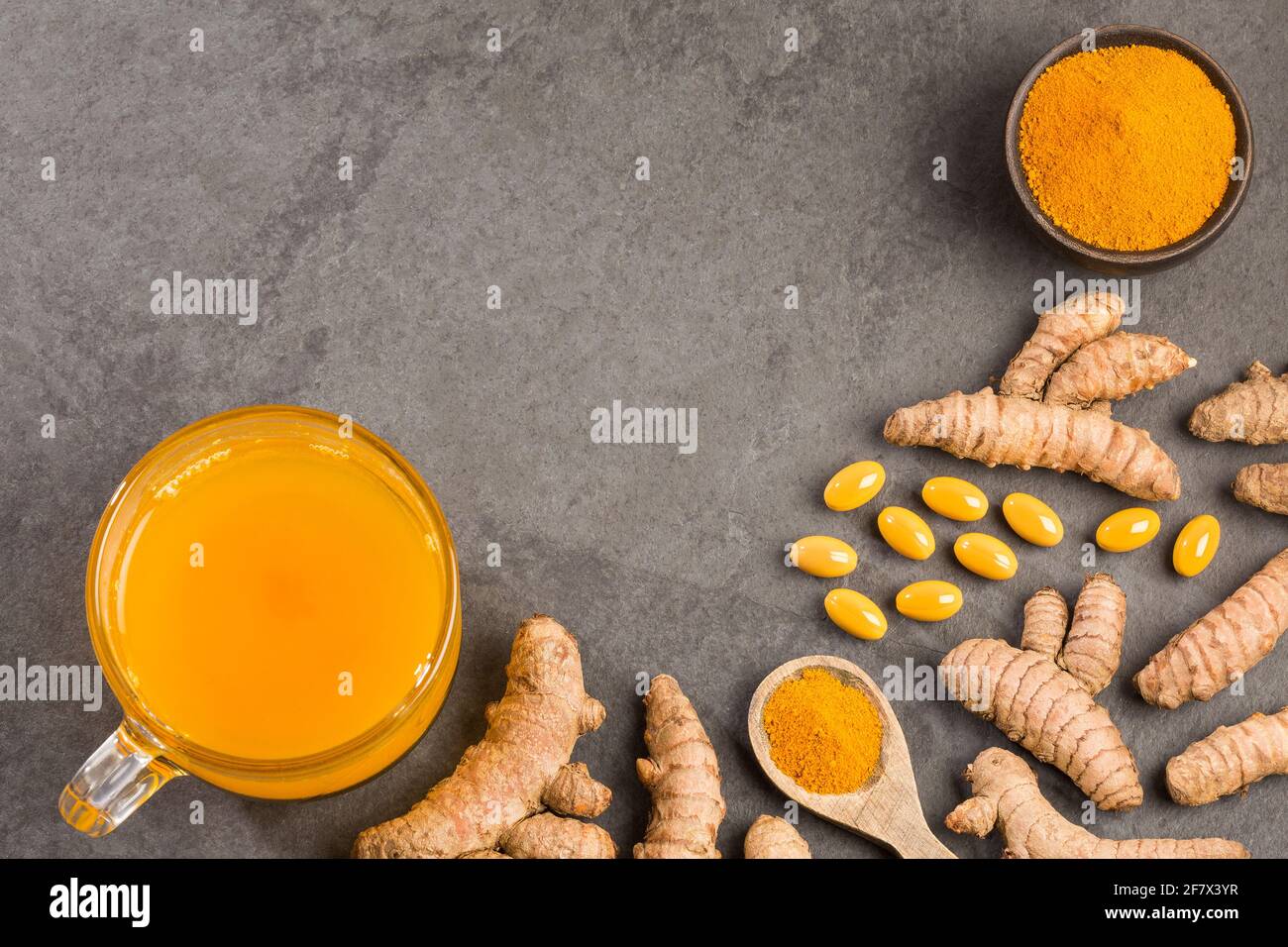 Roots, powder and turmeric pills - Curcuma longa Stock Photo - Alamy