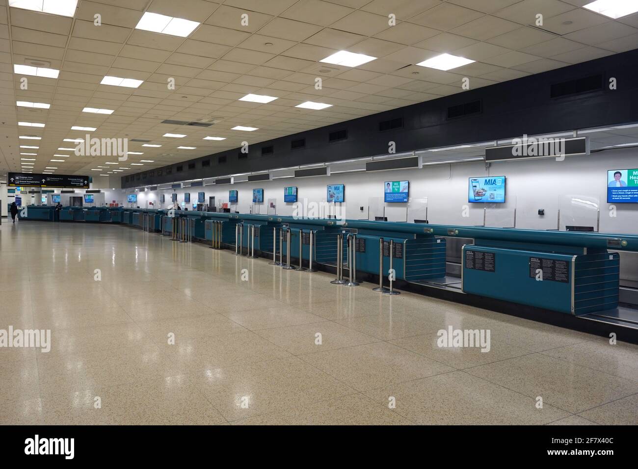 Empty and closed ticket counters at the Miami International Airport ...