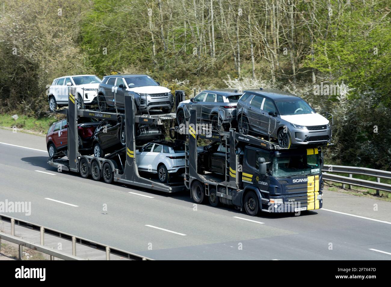 A Scania Carlson transporter lorry carrying new Land Rover cars on the ...
