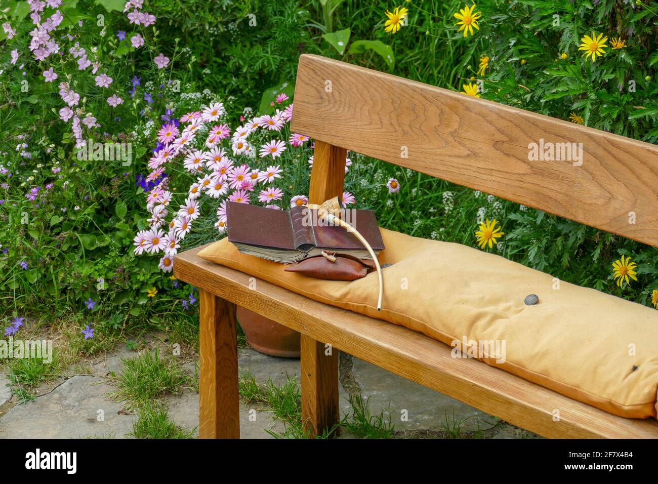 idyllic resting scenery including a smoking pipe and a book on a wooden ...