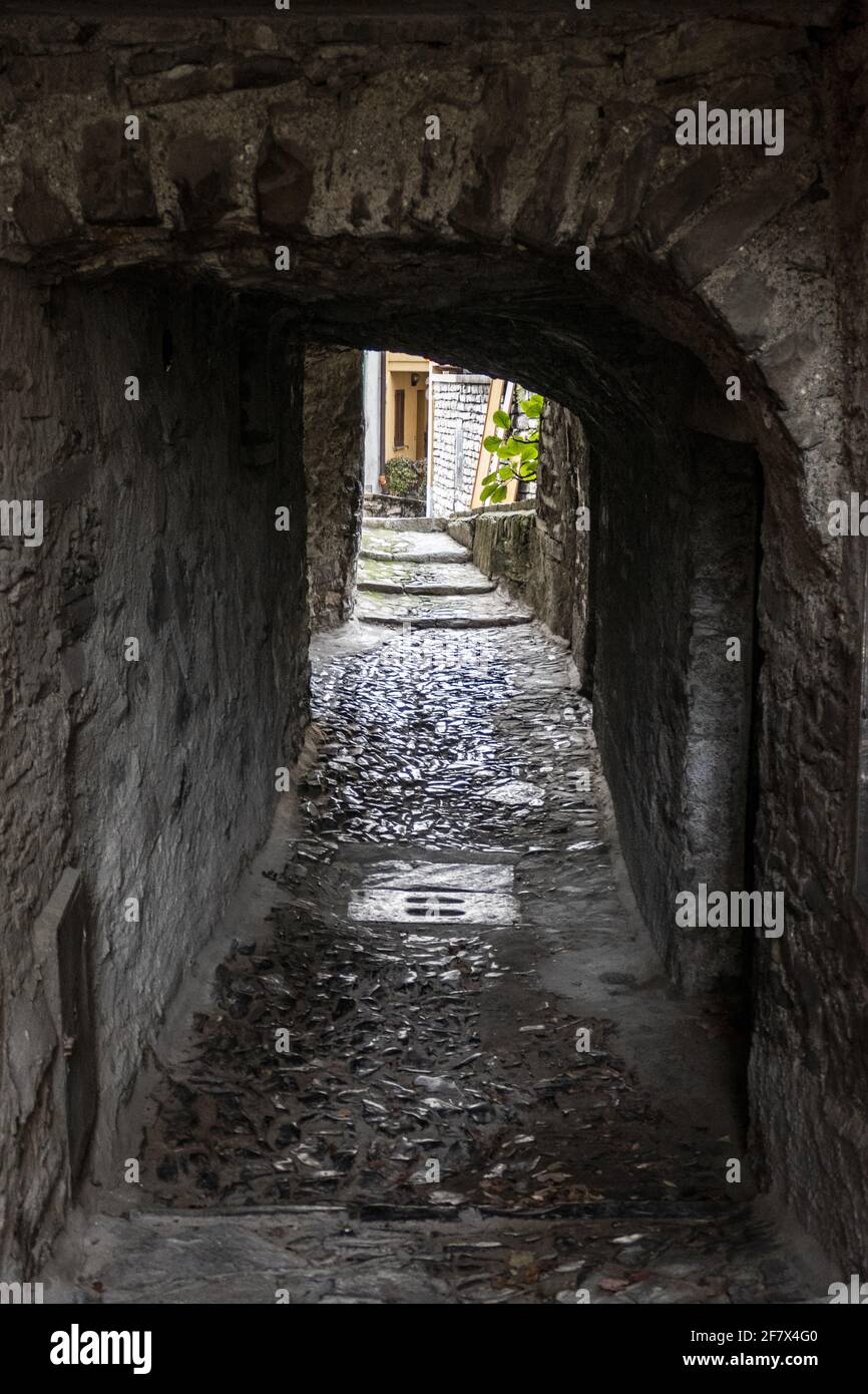 Narrow road with a tunnel from stone at daytime Stock Photo - Alamy