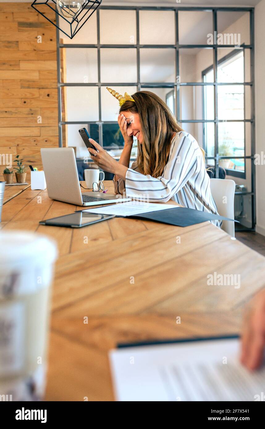 Funny business woman with unicorn headband laughing embarrassed Stock ...