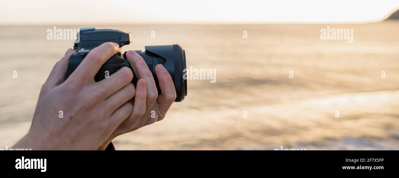 Horizontal banner Side view unrecognizable photographer holding reflex ...