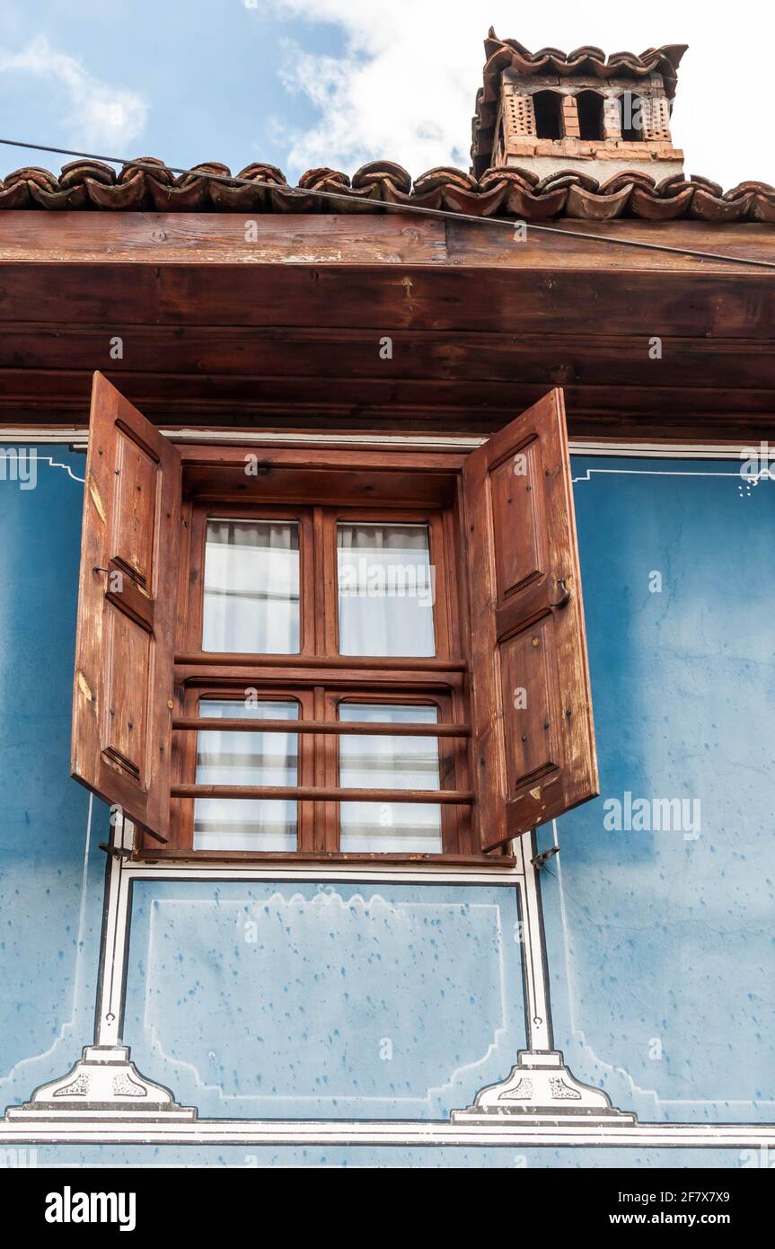 A window in a wooden frame in traditional Bulgarian architecture style ...