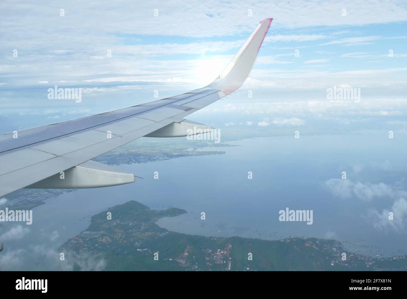 plane wing and cloud floating on sky through window frame Stock Photo ...