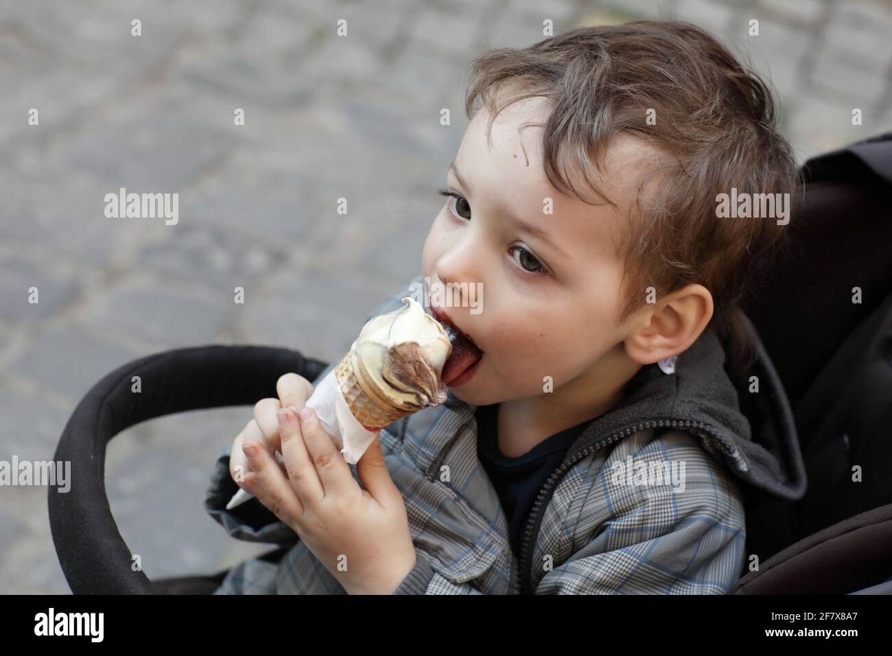 Child with ice cream in the stroller Stock Photo - Alamy