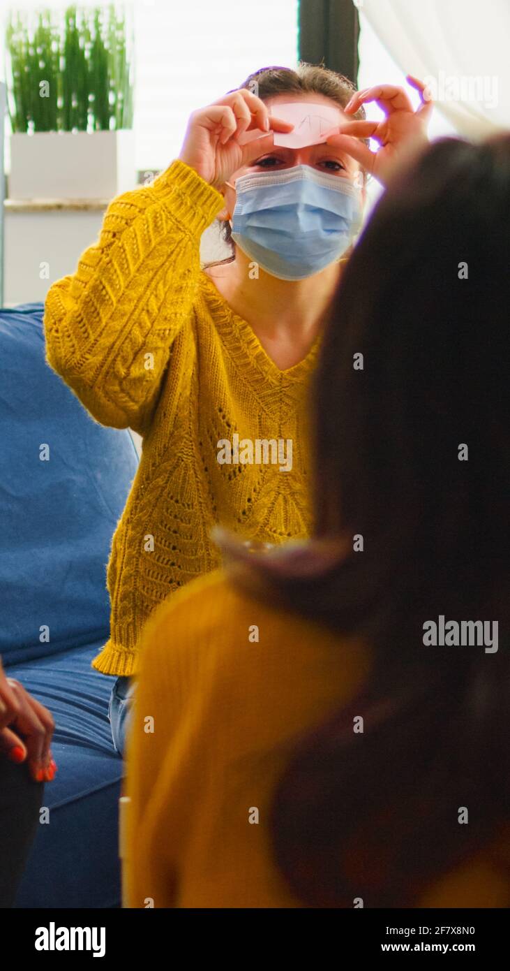Happy woman with sticky note on forehead playing name game with ...